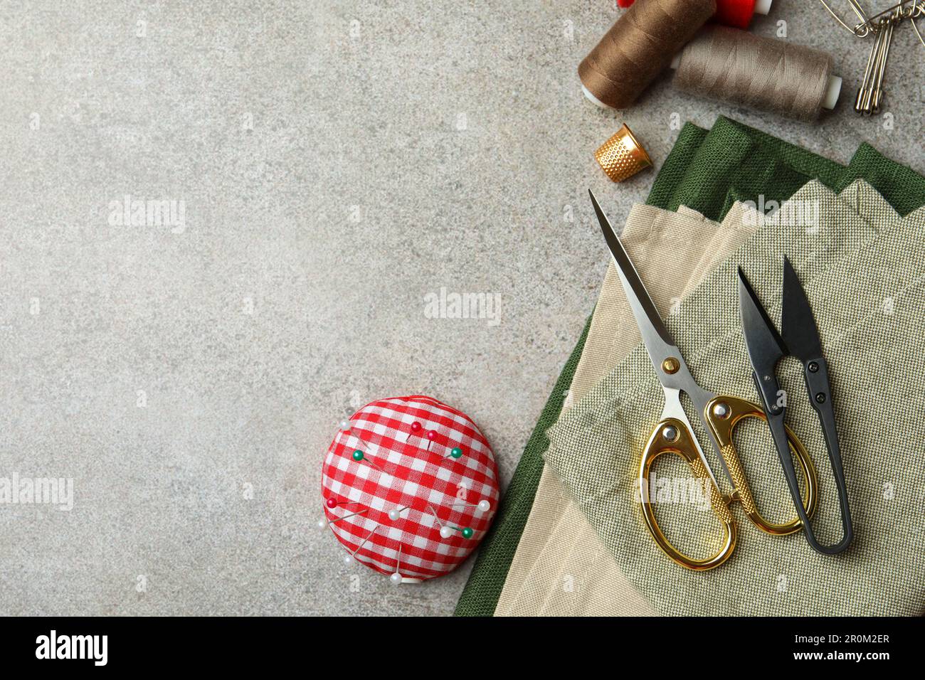 Flat lay composition with spools of threads and sewing tools on light ...