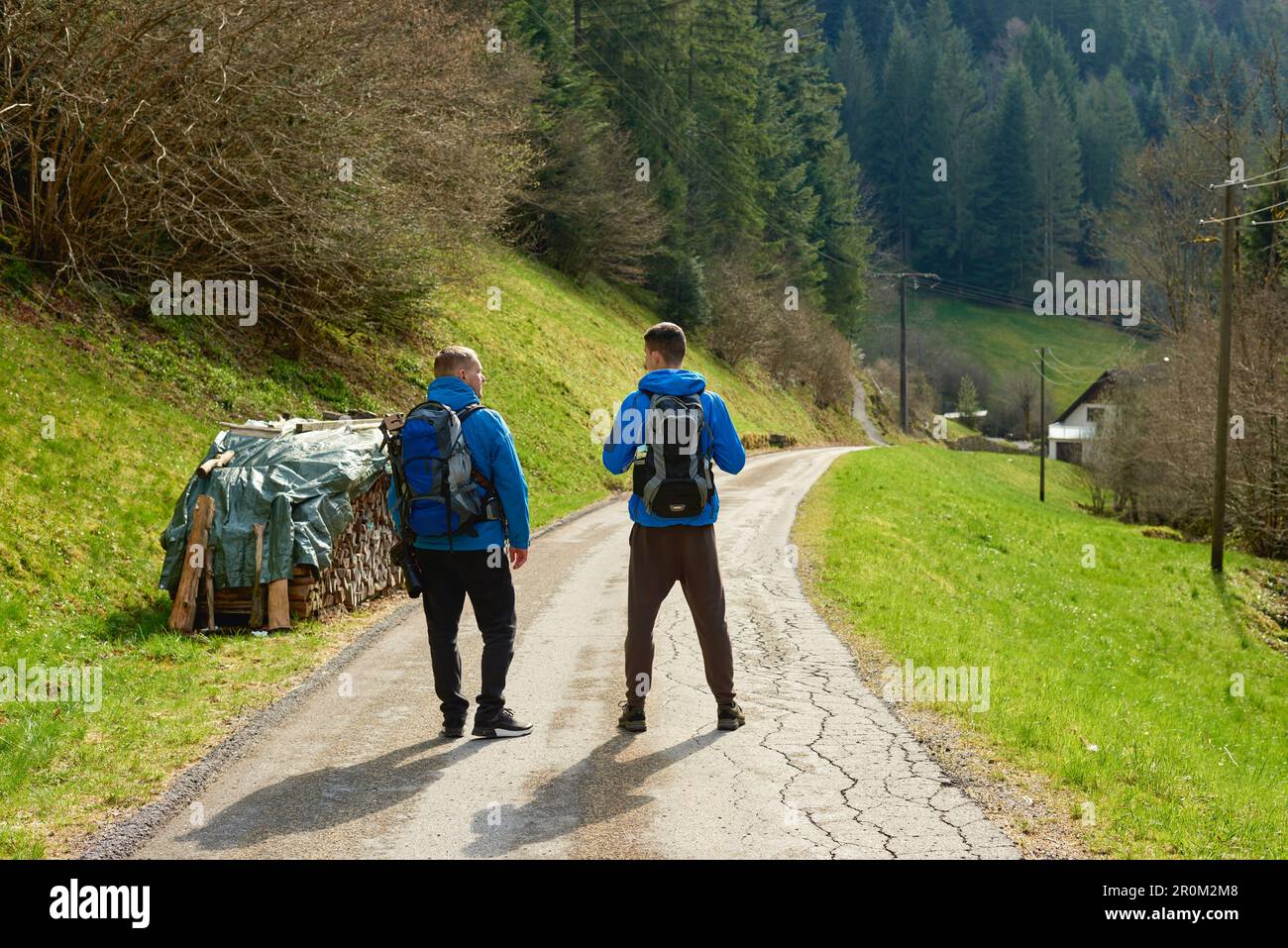 Two hikers are in the mountains in the spring nature outdoor. Hiking ...