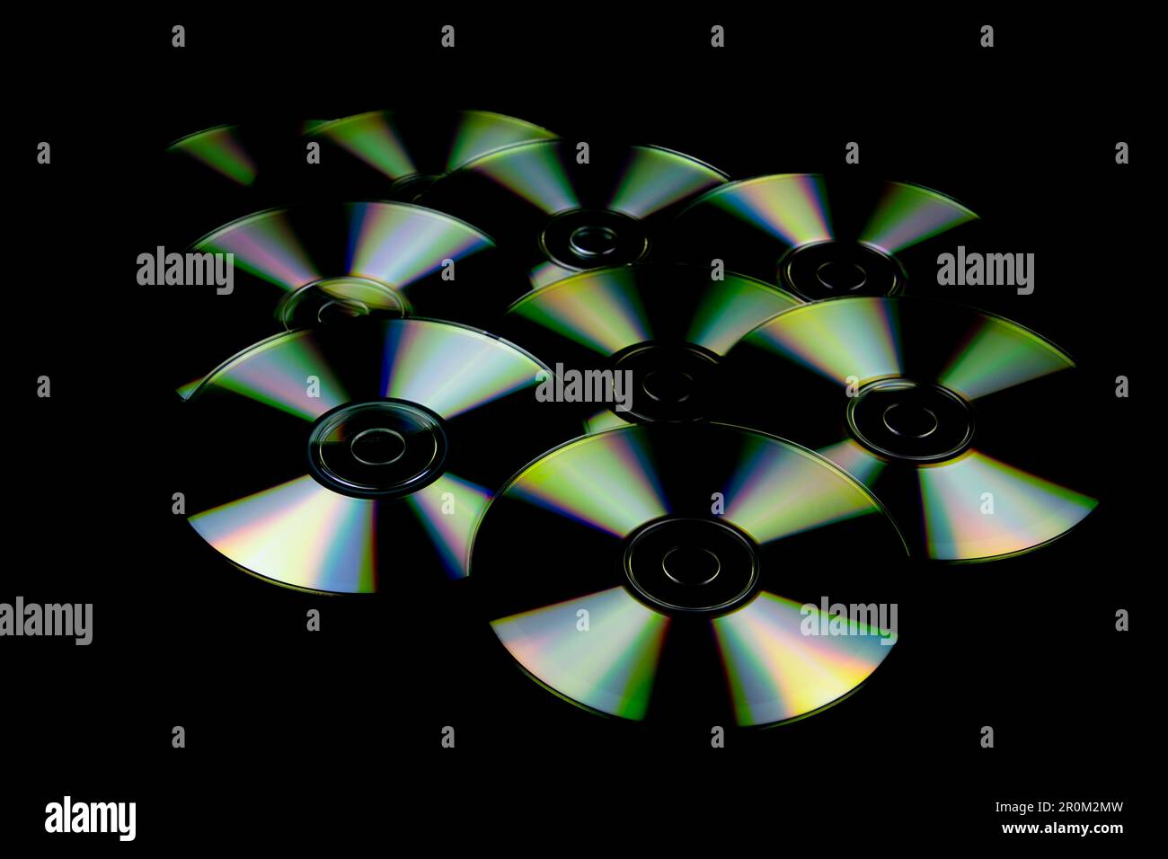 CD and DVD isolated on black background with colorful light reflections ...