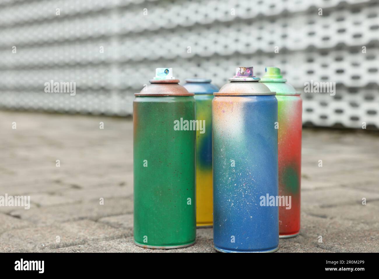 Used cans of spray paints on pavement, closeup Stock Photo - Alamy