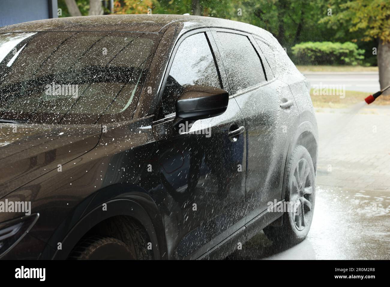 Washing auto with high pressure water jet at outdoor car wash Stock ...