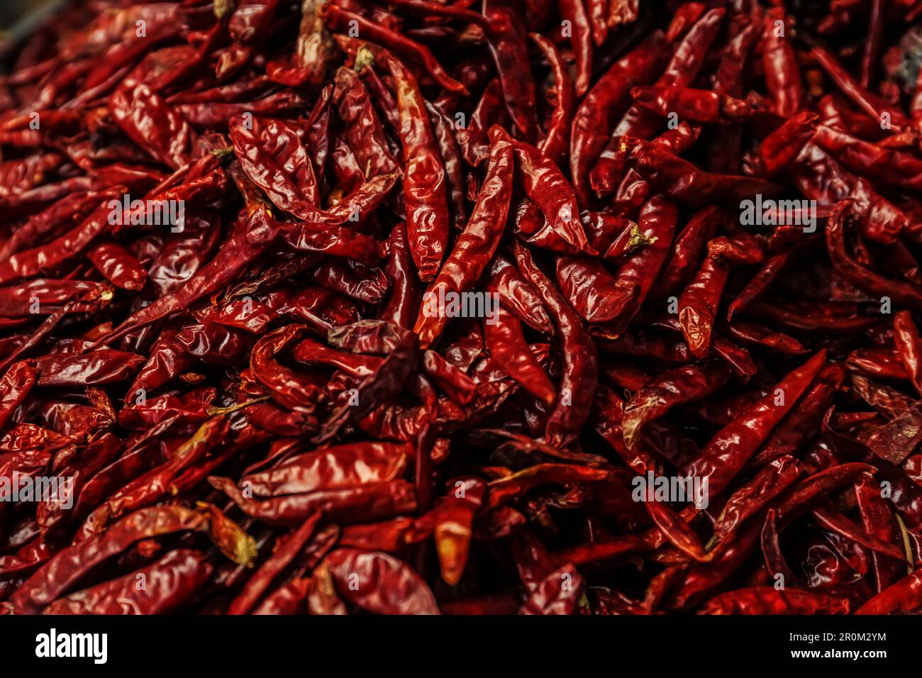 Pile of spicy dried red chiles as background, top view Stock Photo - Alamy