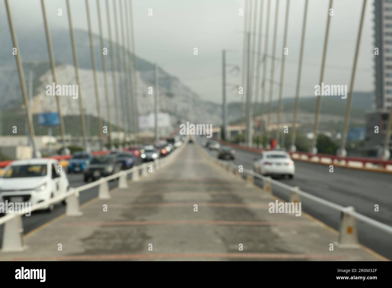Blurred view of modern bridge with cars near city Stock Photo - Alamy