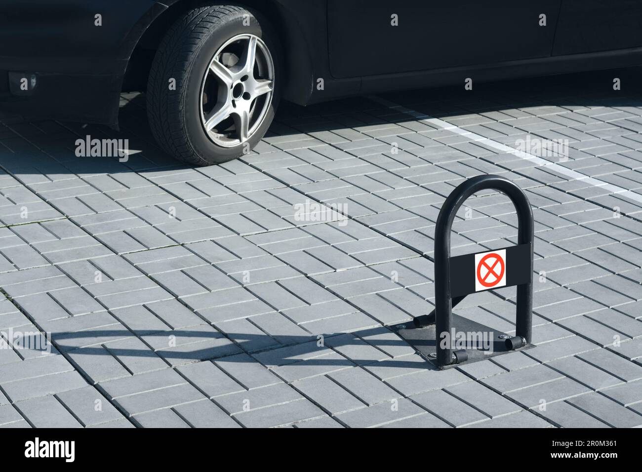 Parking barrier with No Stopping road sign on pavement near car, space ...