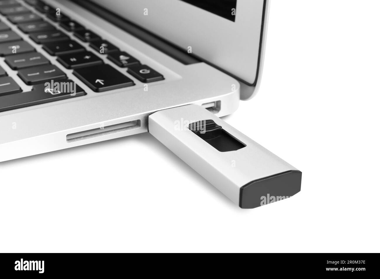 Modern usb flash drive attached into laptop on white background ...