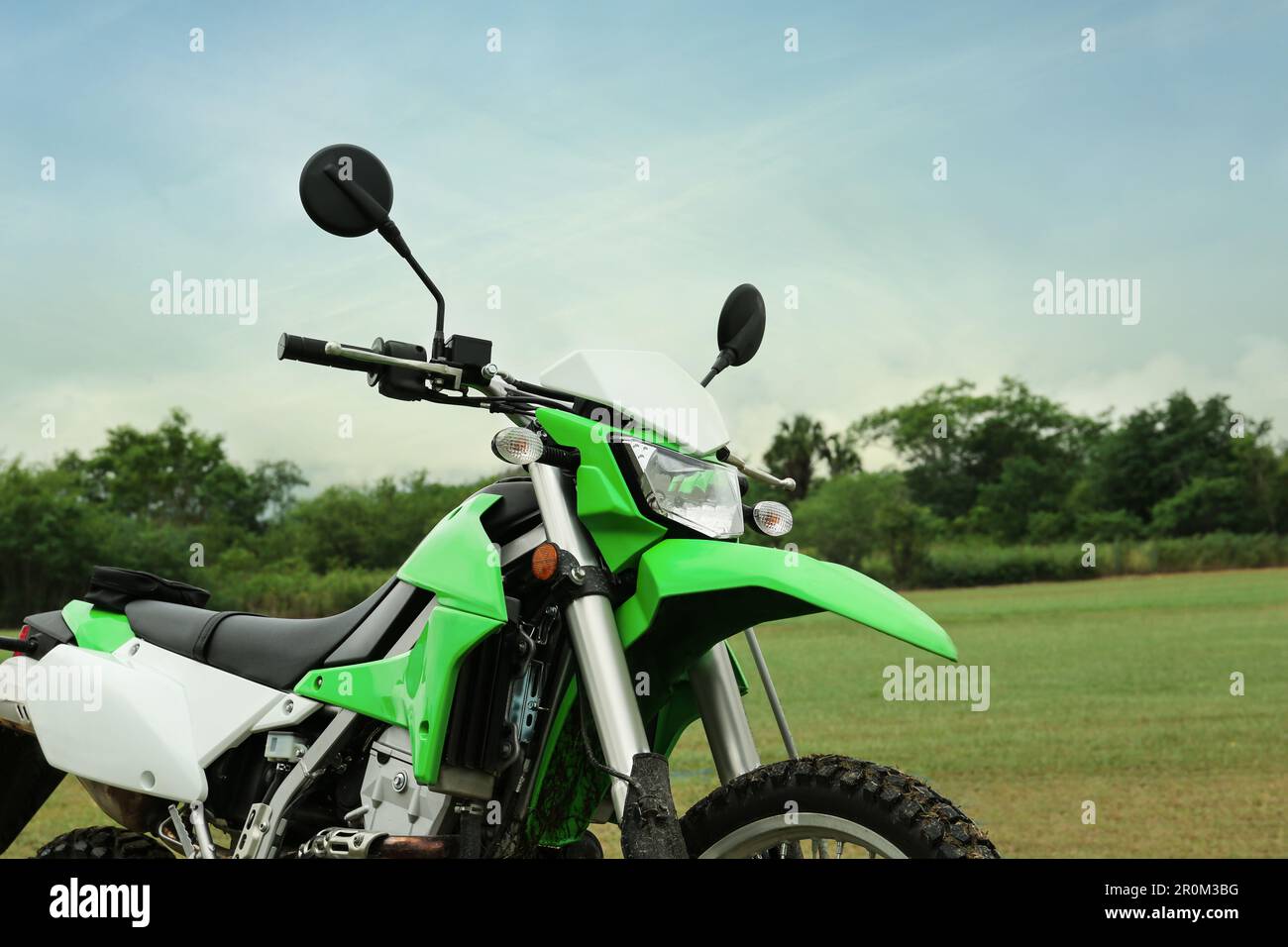 Stylish green cross motorcycle on grass outdoors Stock Photo - Alamy