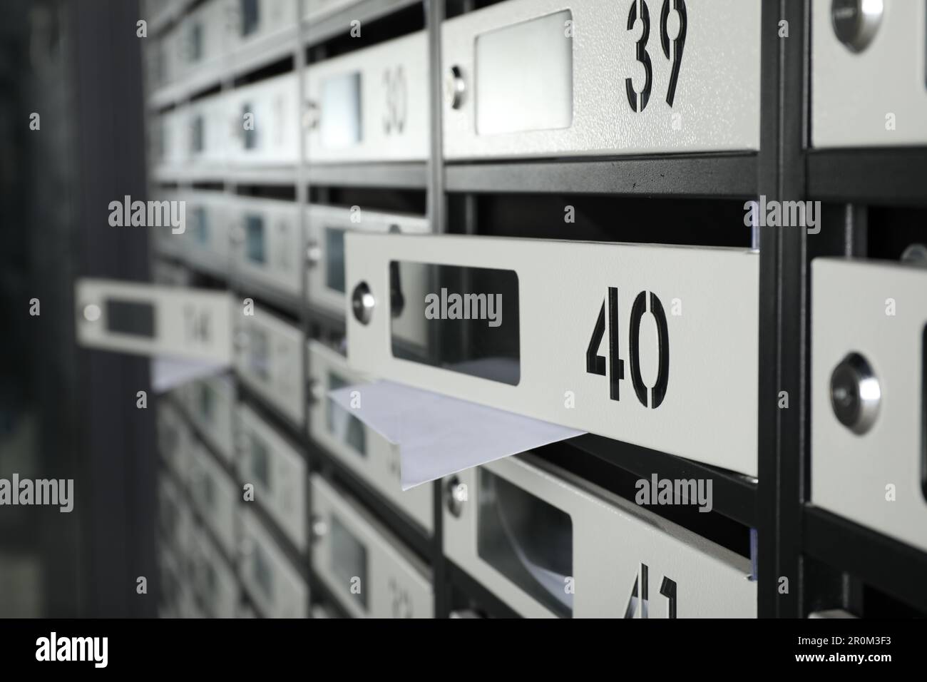 Open mailboxes with keyholes, numbers and receipts, closeup Stock Photo ...