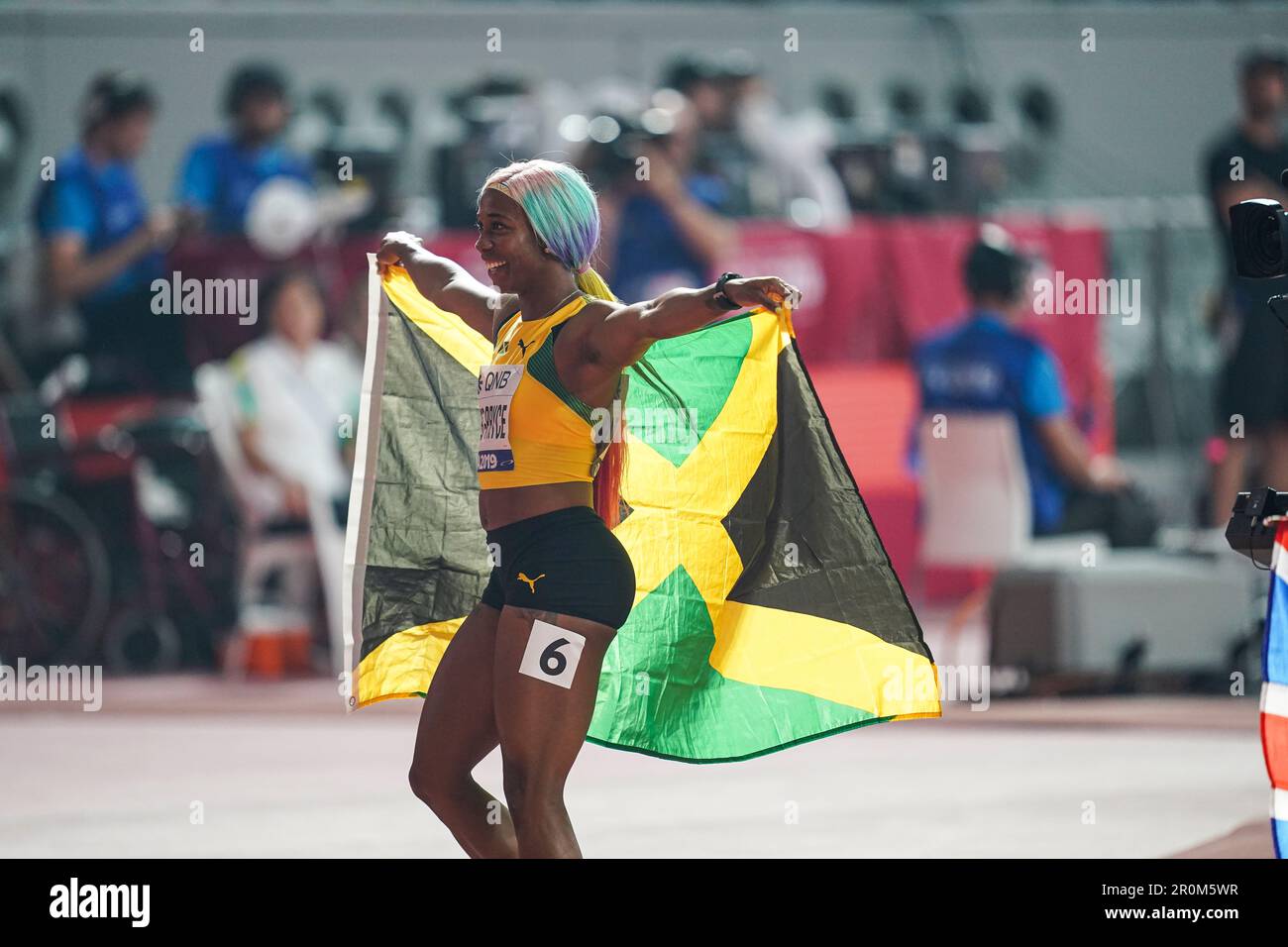 Shelly-Ann Fraser-Pryce with her country's flag after medaling in the ...