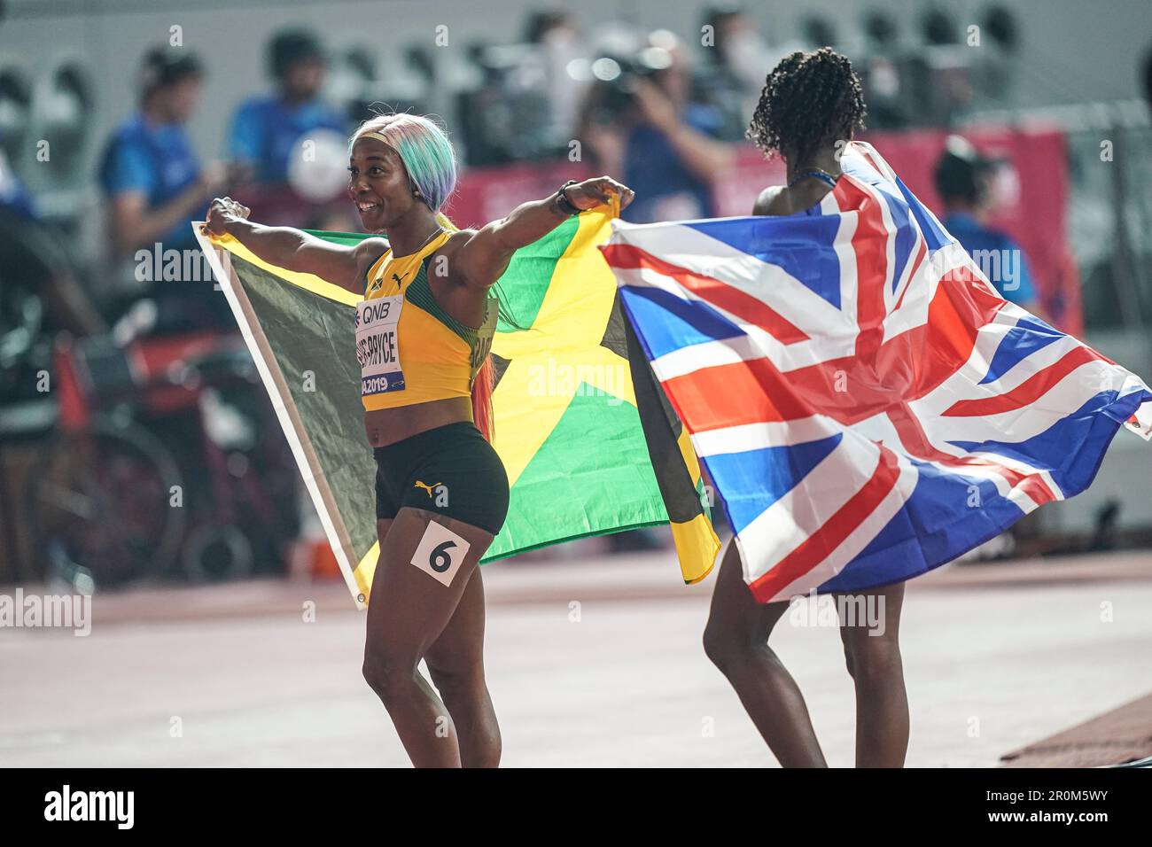 Shelly-Ann Fraser-Pryce with her country's flag after medaling in the ...