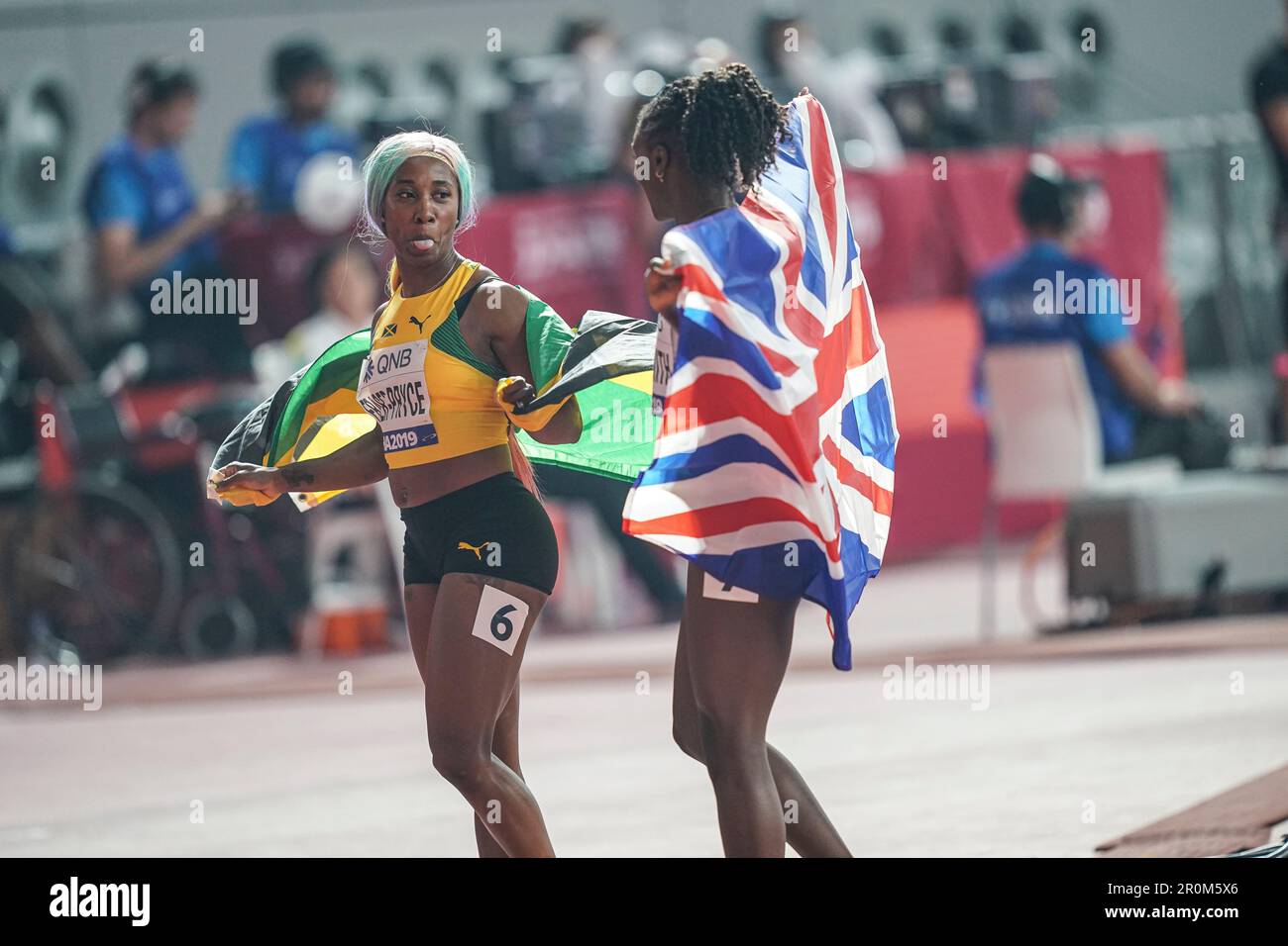 Shelly-Ann Fraser-Pryce with her country's flag after medaling in the ...