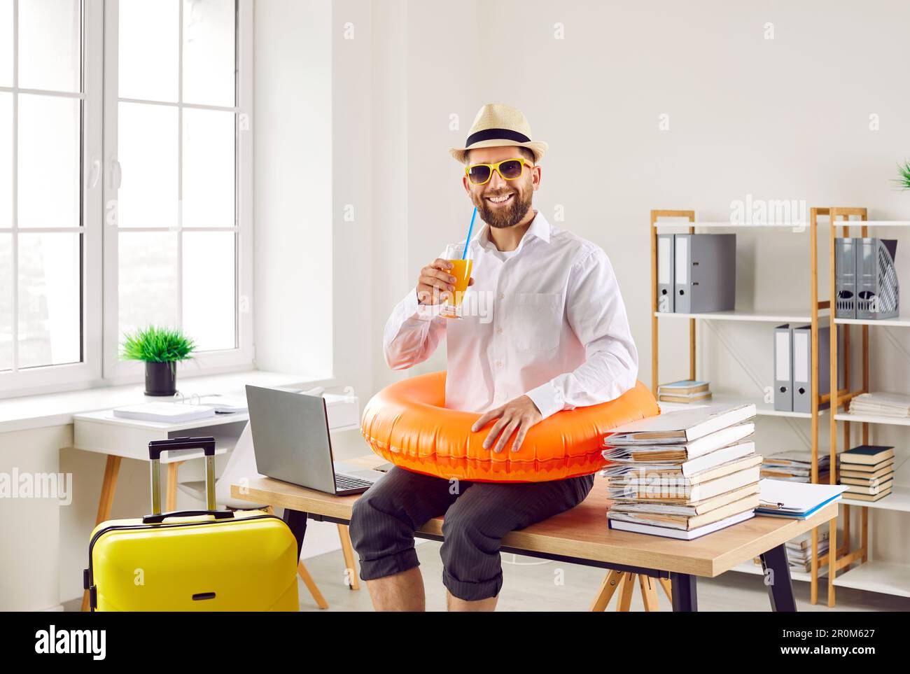 Funny happy male office employee ready to go on summer vacation on his ...
