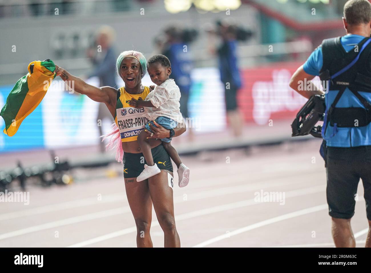 Shelly-Ann Fraser-Pryce with her son in her arms after winning the 100m ...
