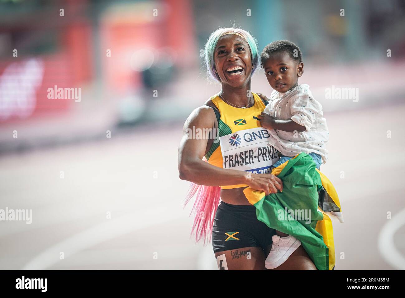 Shelly-Ann Fraser-Pryce with her son in her arms after winning the 100m ...