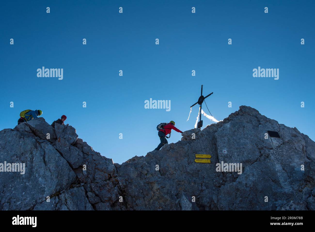 Climbers on arrival on the center peak of Watzmann, summit cross in ...
