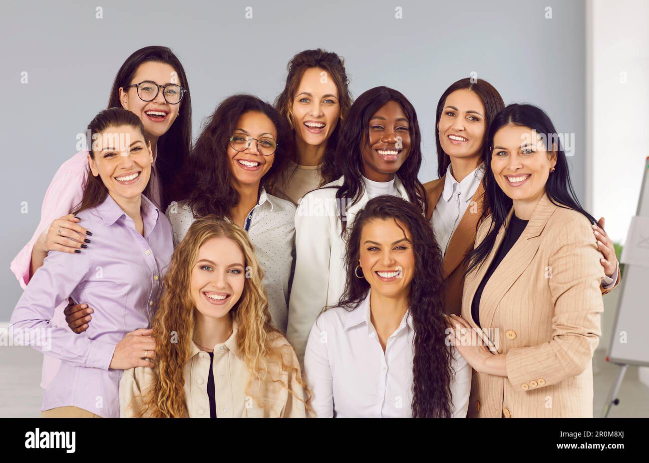 Happy cheerfull young diverse women friends or coworkers looking at ...