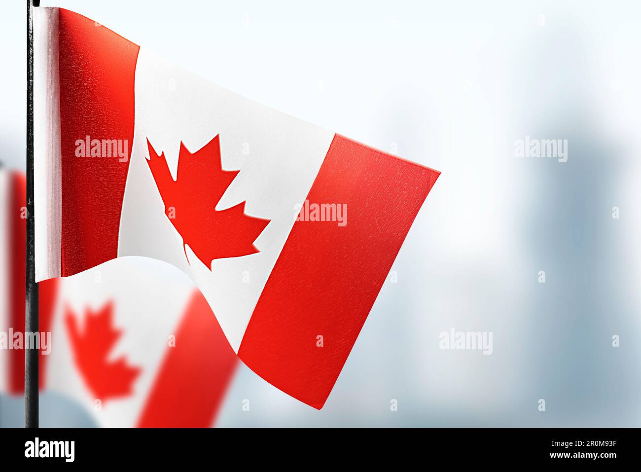 National flags of Canada on blurred background Stock Photo - Alamy