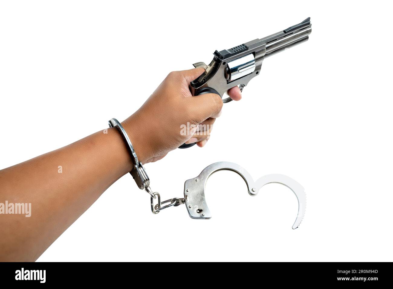 Arrested man with a handcuff on his hand holding a handgun isolated ...
