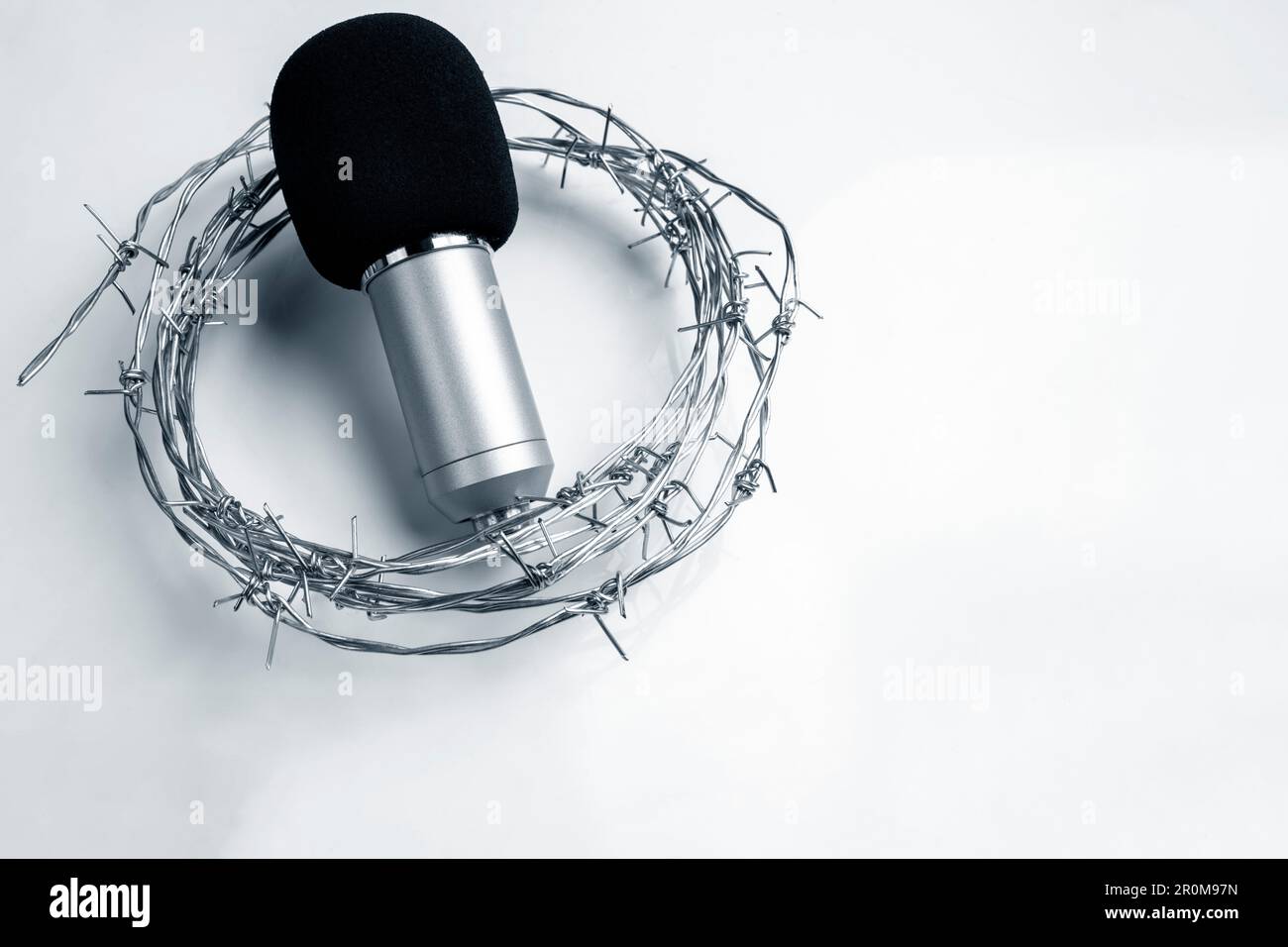 Microphone and barbed wire on white background Stock Photo - Alamy
