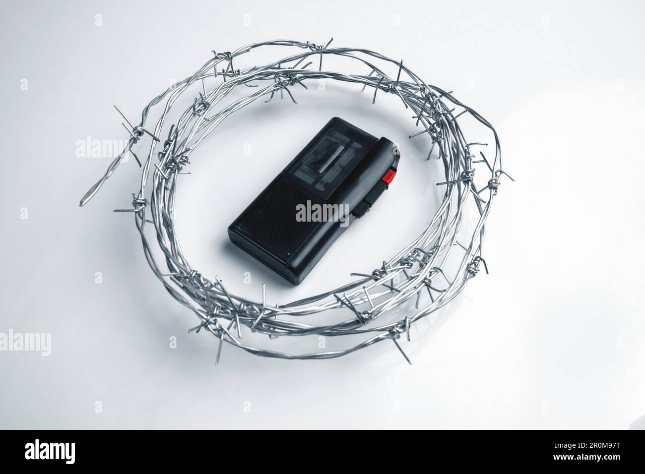 Recording device and barbed wire on white background Stock Photo - Alamy