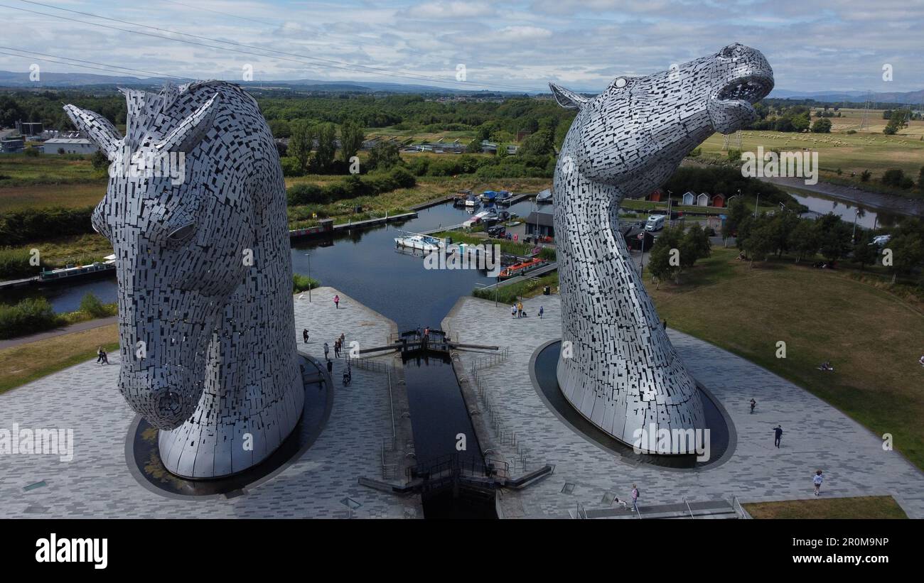 An aerial shot of a sculpture of two horseheads, The Kelpies in the ...