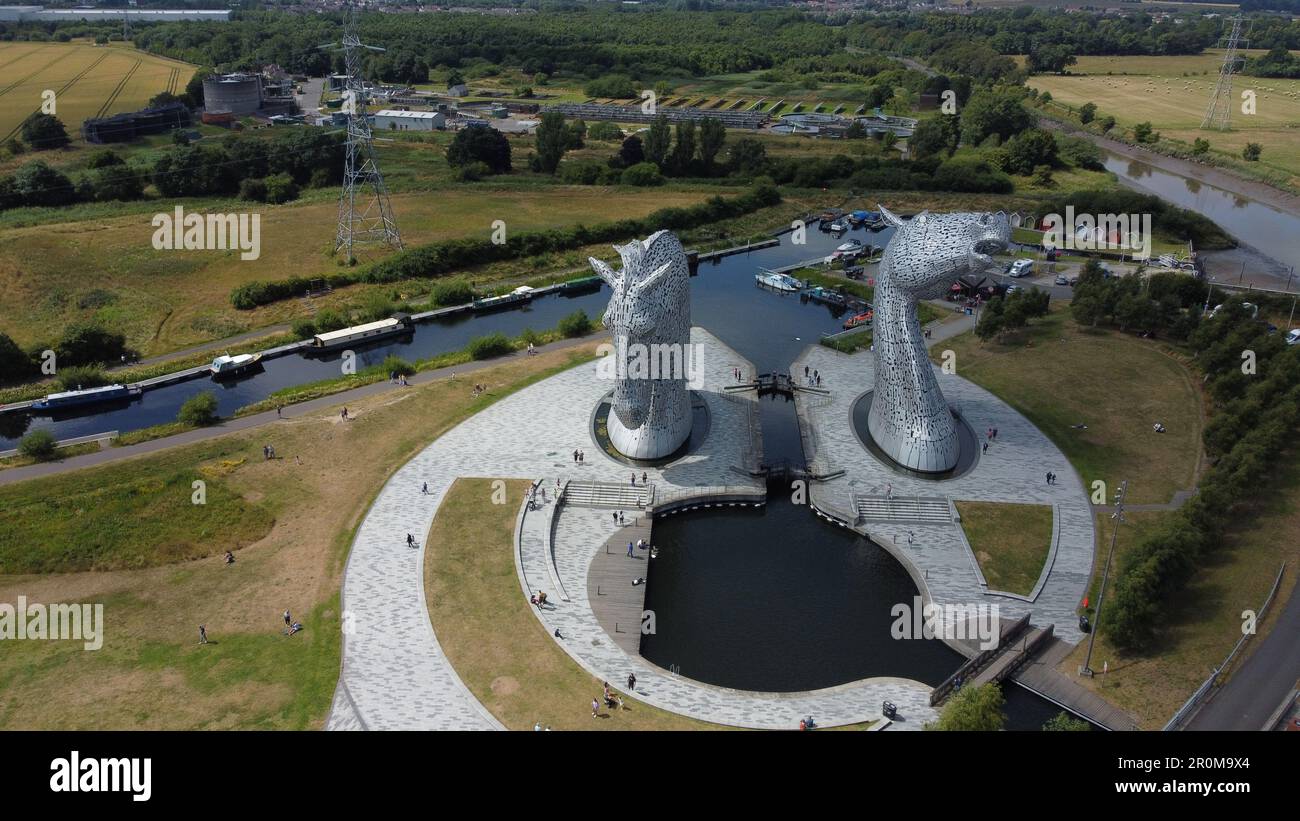 An aerial shot of a sculpture of two horseheads, The Kelpies in the ...