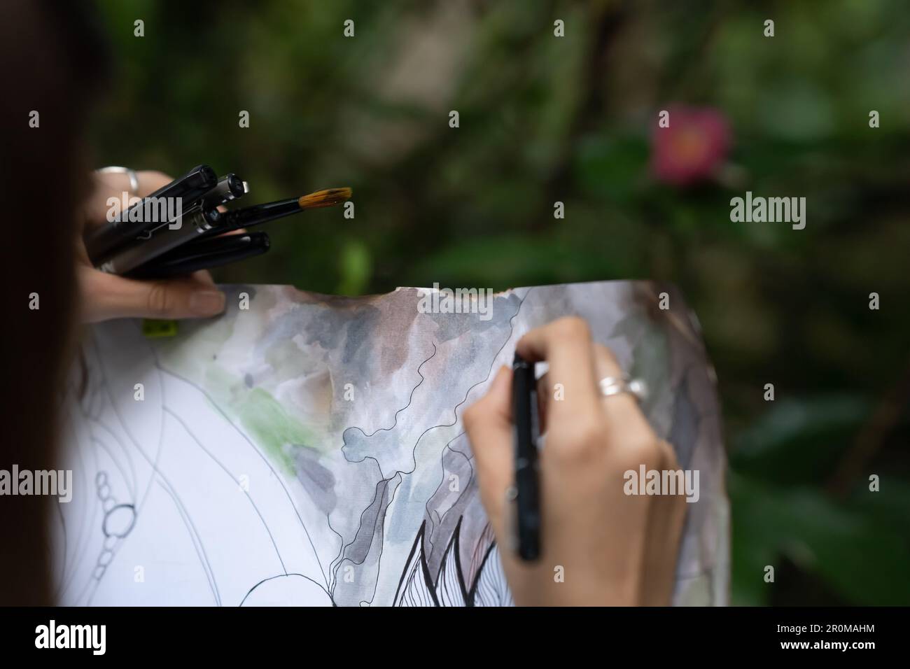 artist's hands close-up Close-up of a woman's hand mixing paints with a ...