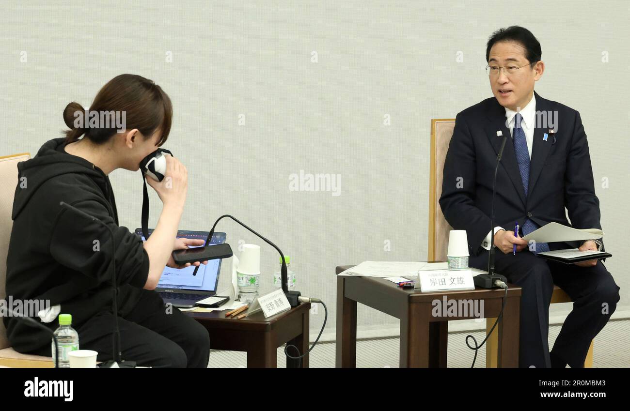 Japanese Prime Minister Fumio Kishida (R) has a dialogue with a next ...