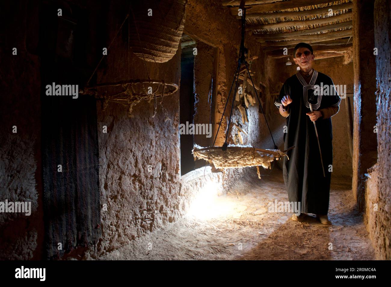 Old blind man, Berber, leads through a traditional Berber house, Valley ...