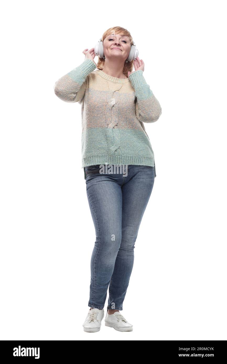 in full growth. attractive casual woman listening to music through ...