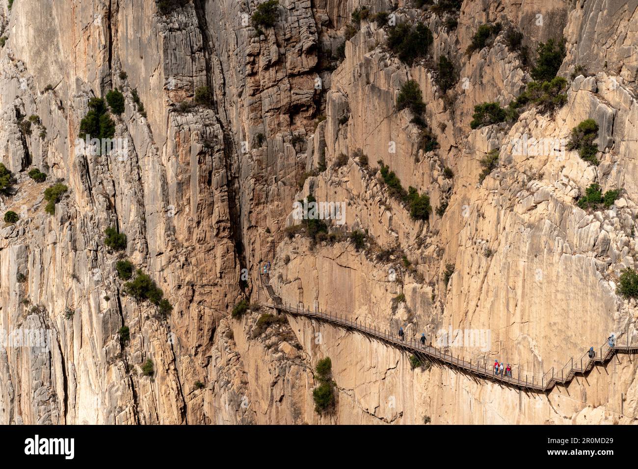 The tourists walking along a cliffside path at Caminito del Ray, Spain ...