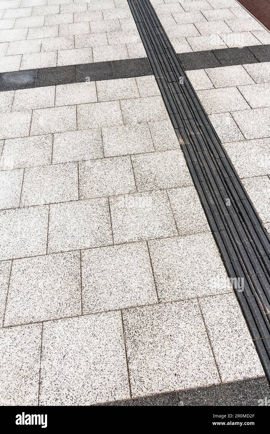 Textured walkway for blind people. Black tactile paving for the ...