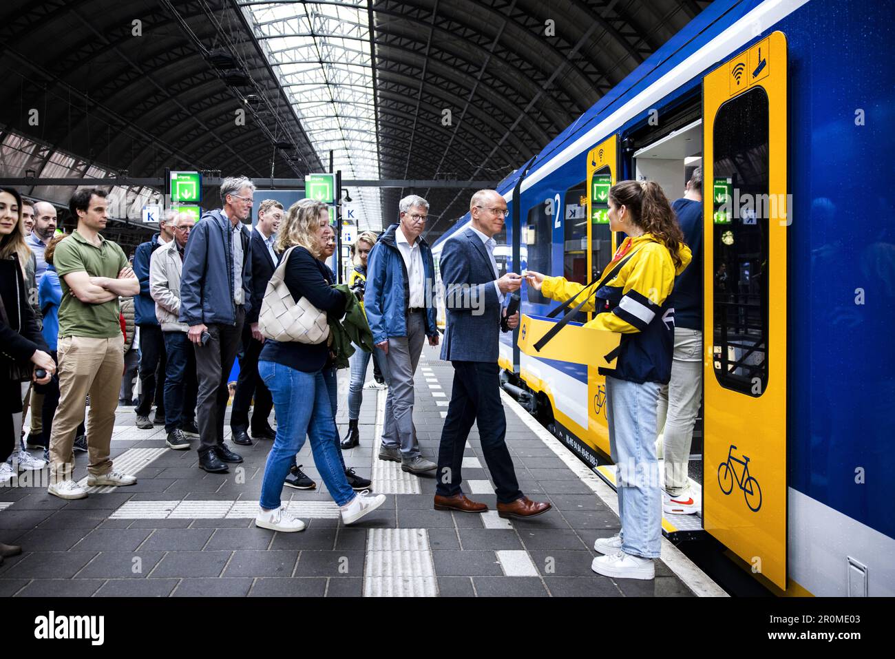 AMSTERDAM - Travelers board the new Sprinter at Amsterdam Central. A ...