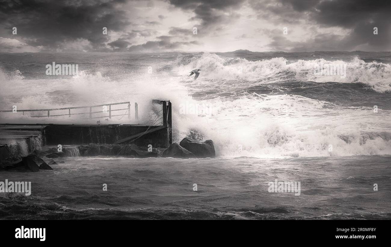 A dark and moody image of a stormy sea, captured in grayscale tones to ...
