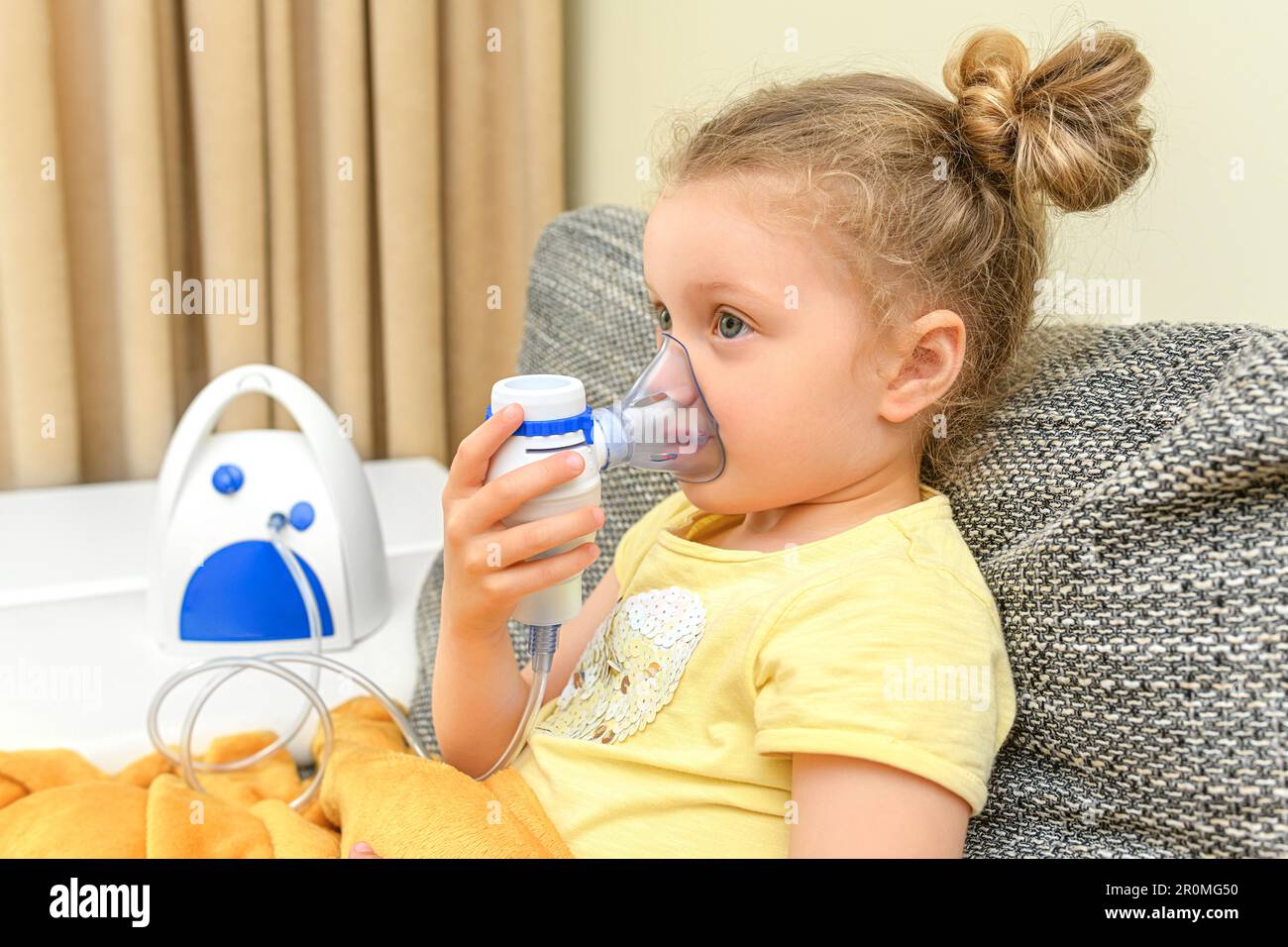 The child breathes through an inhaler Stock Photo - Alamy
