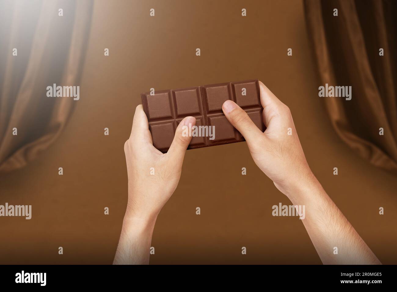 Human hand holding the chocolate bar. World chocolate day concept Stock ...