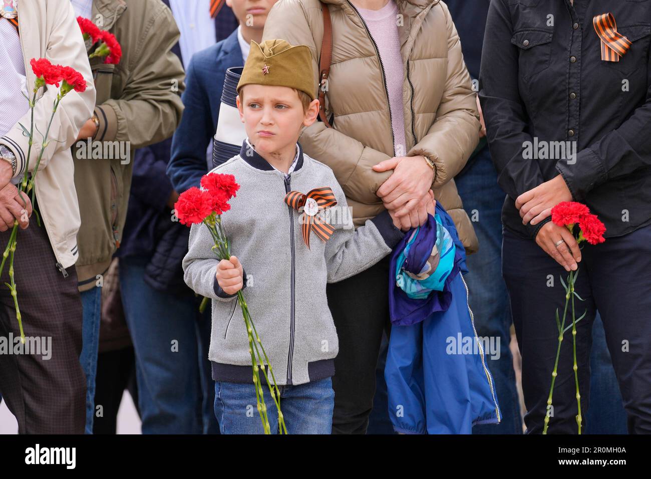 A boy wearing a World War II guerrilla cap with the five-point star ...