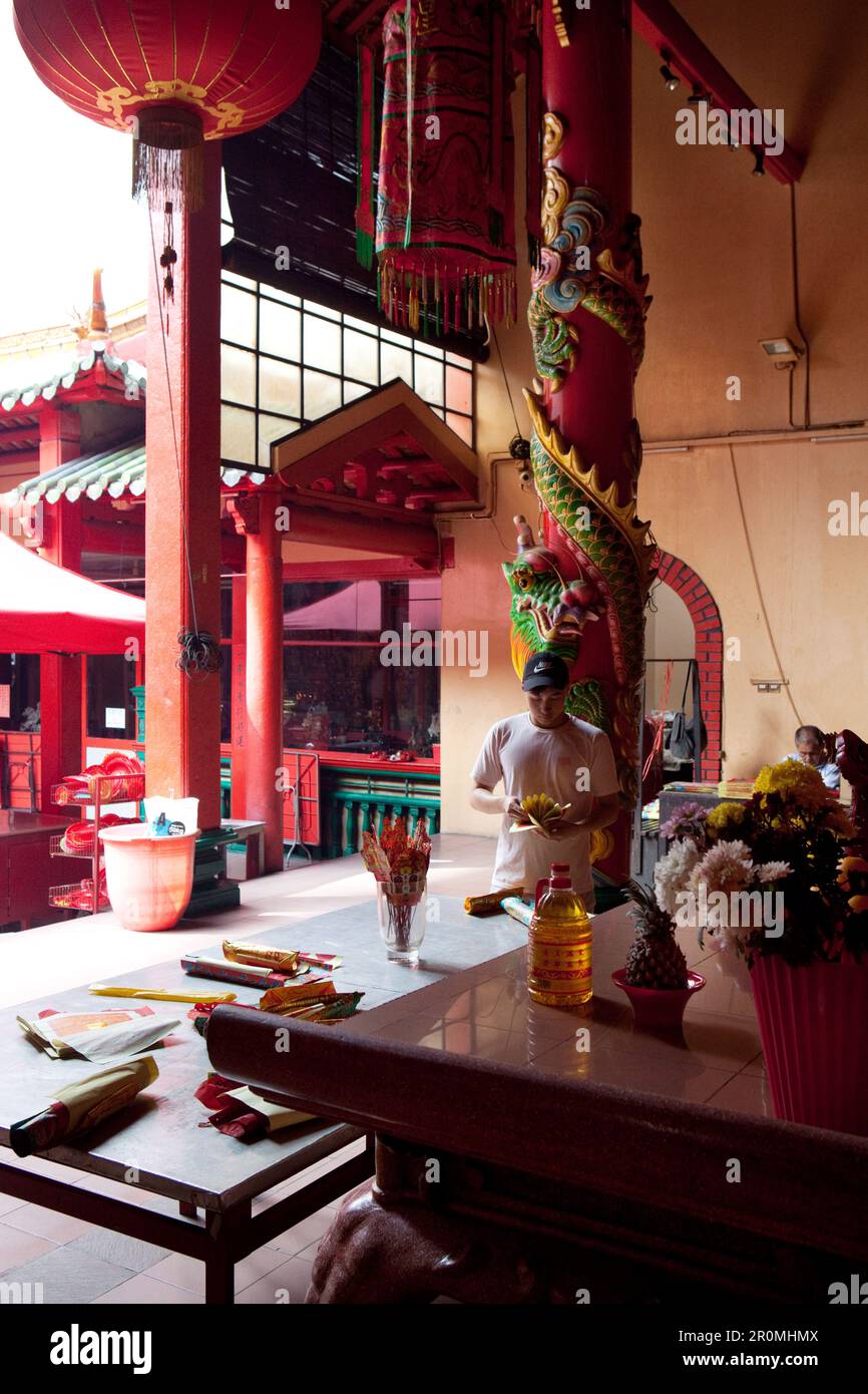 Believer with offerings in Chinese temple in Kuala Lumpur, Kuala Lumpur ...