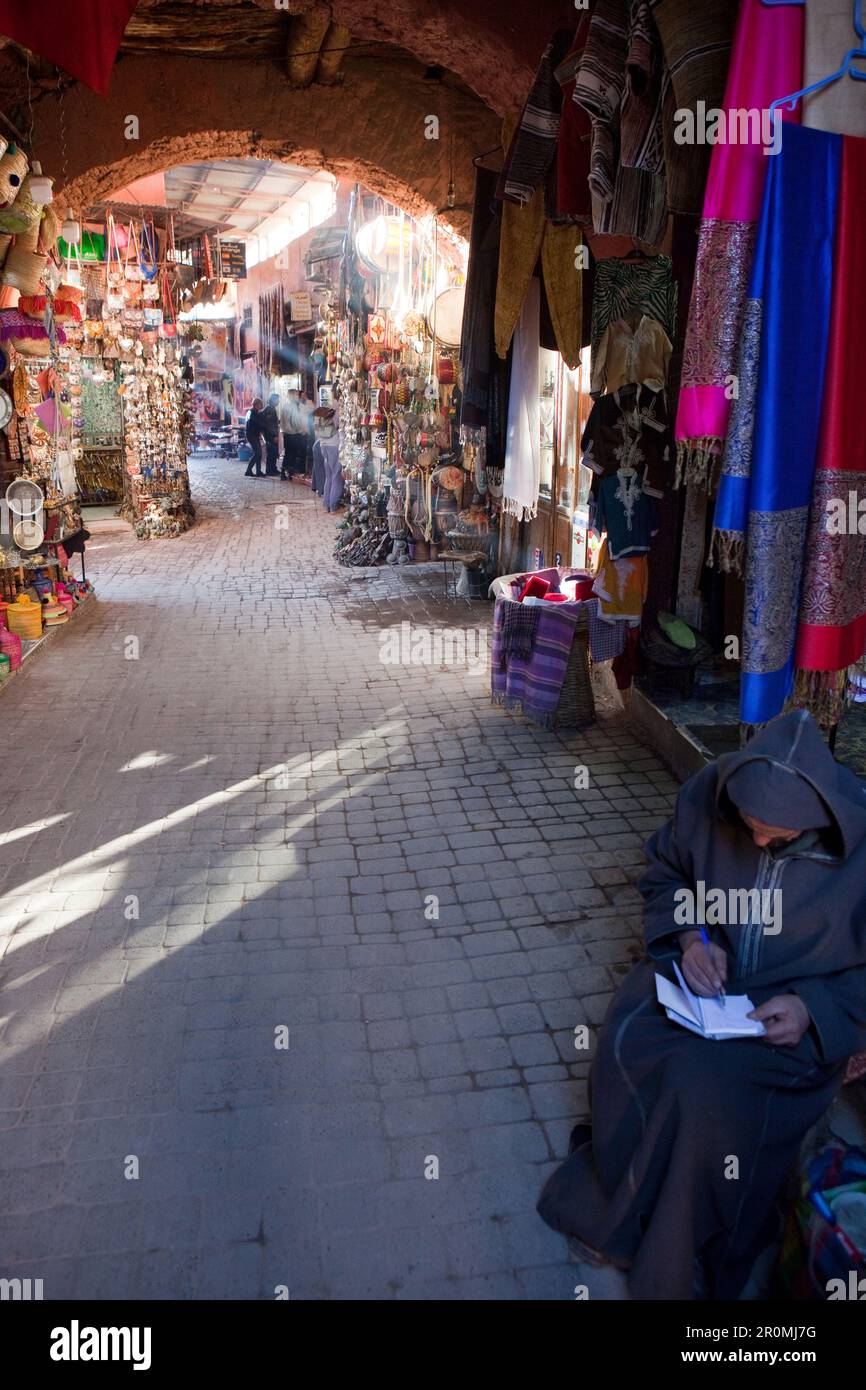 Salesman with traditional garment in front of his business in the ...