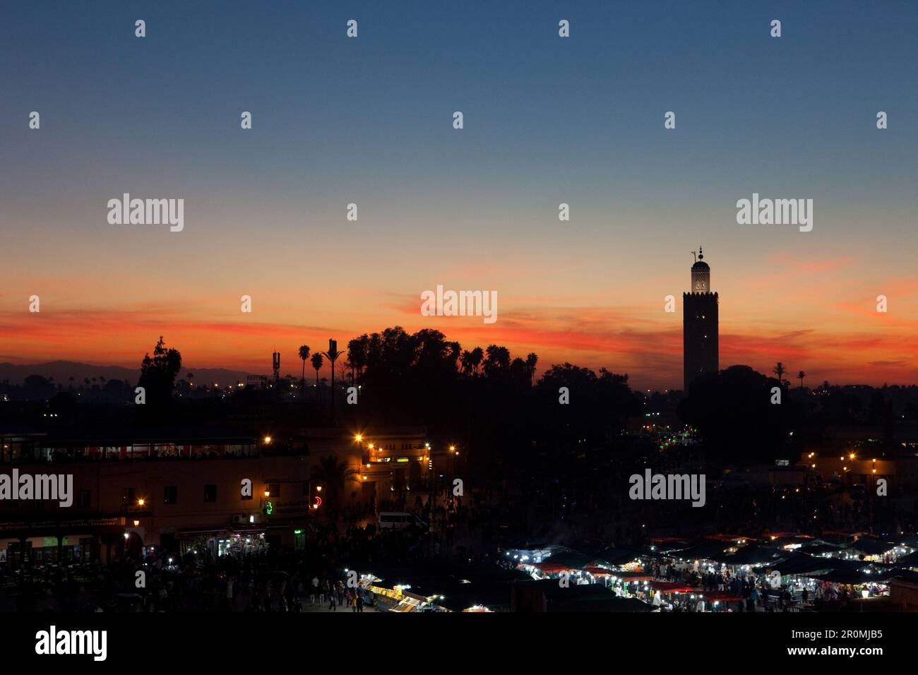 View from a rooftop bar at night over the main square Djemaa el-Fna and ...