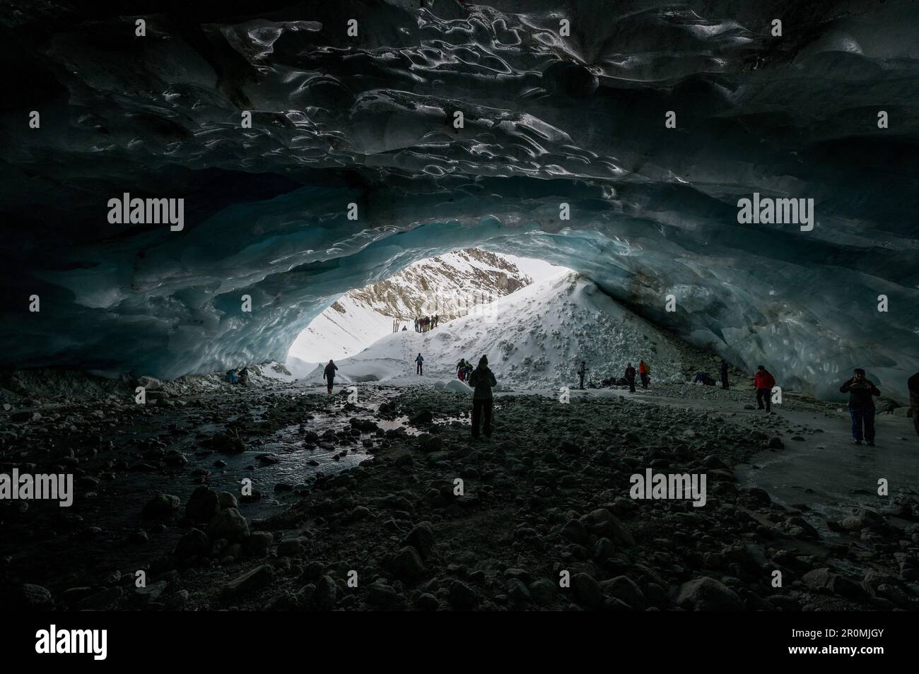 entrance to an deep blue ice ice cave in the Valais Alps Stock Photo ...