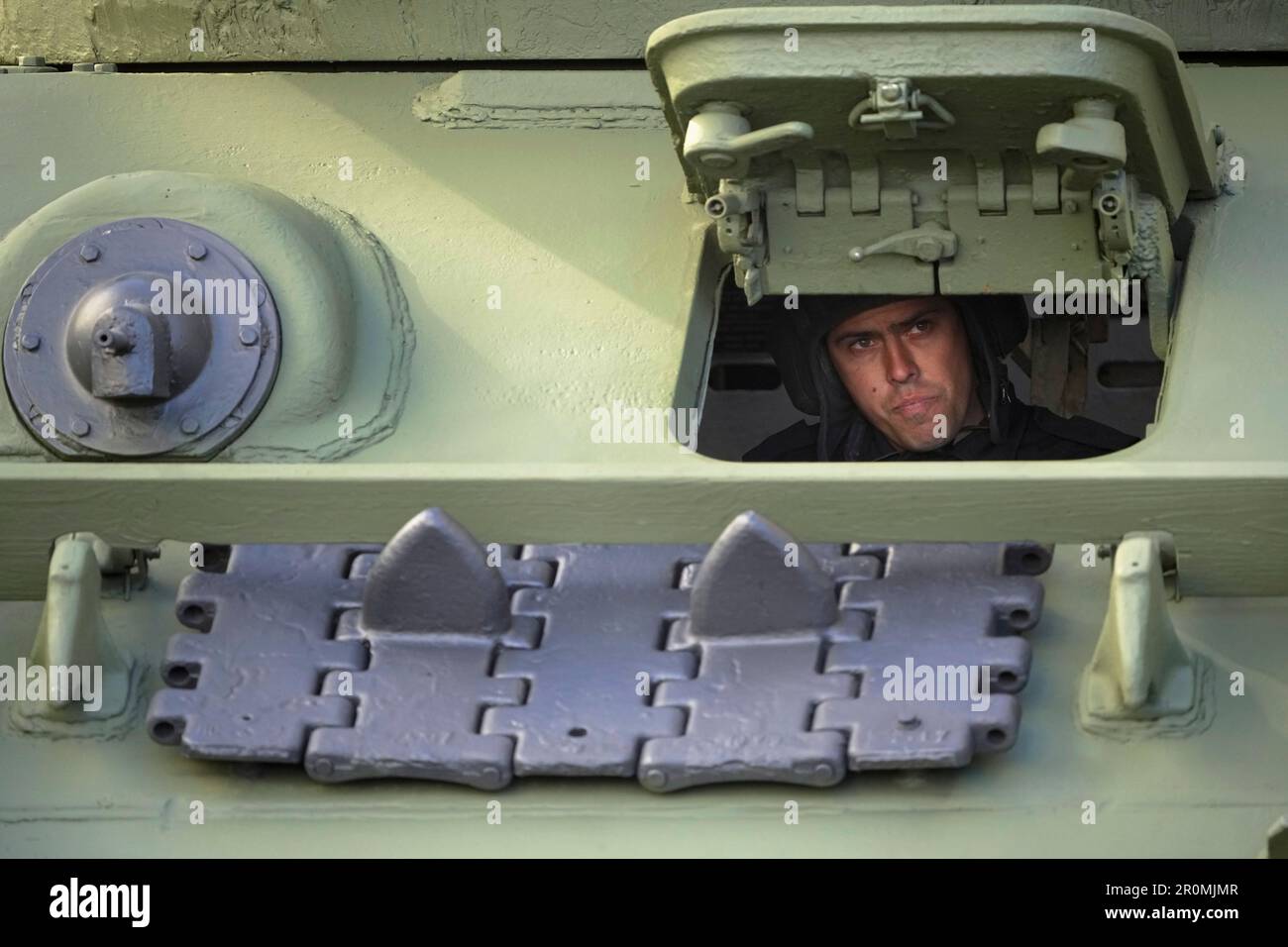 A driver of a World War II age Soviet army T-34 tank looks on prior to ...