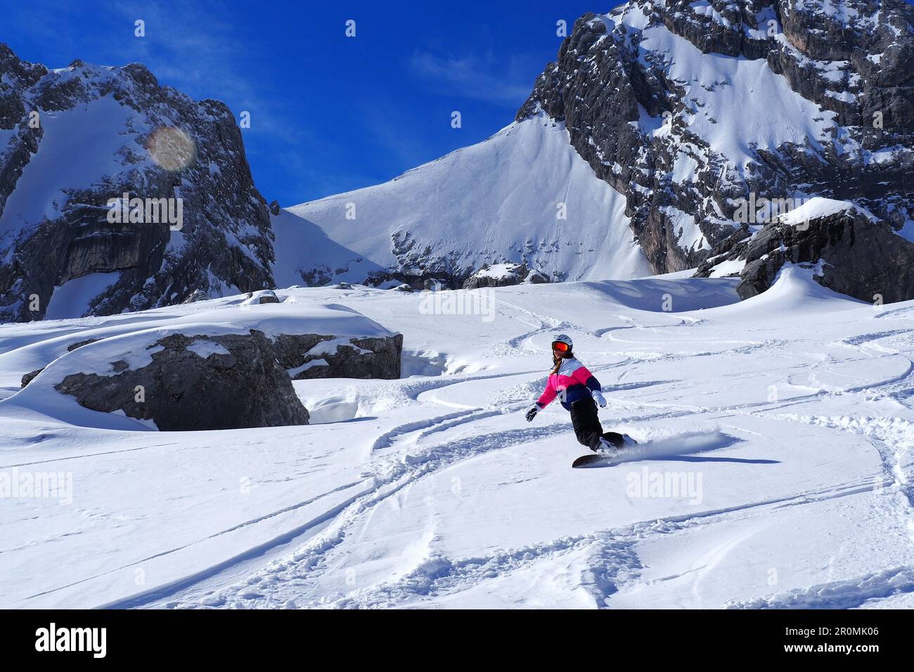 Snowboarder on wild descent, skiing in the White Valley under the ...