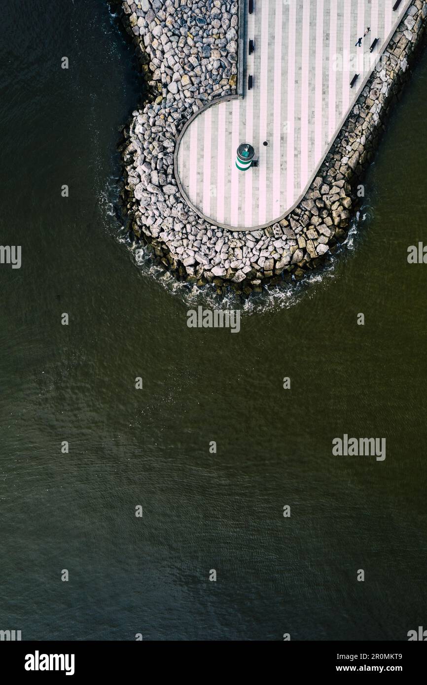 An aerial view of a lighthouse on a harbor against the sea Stock Photo ...