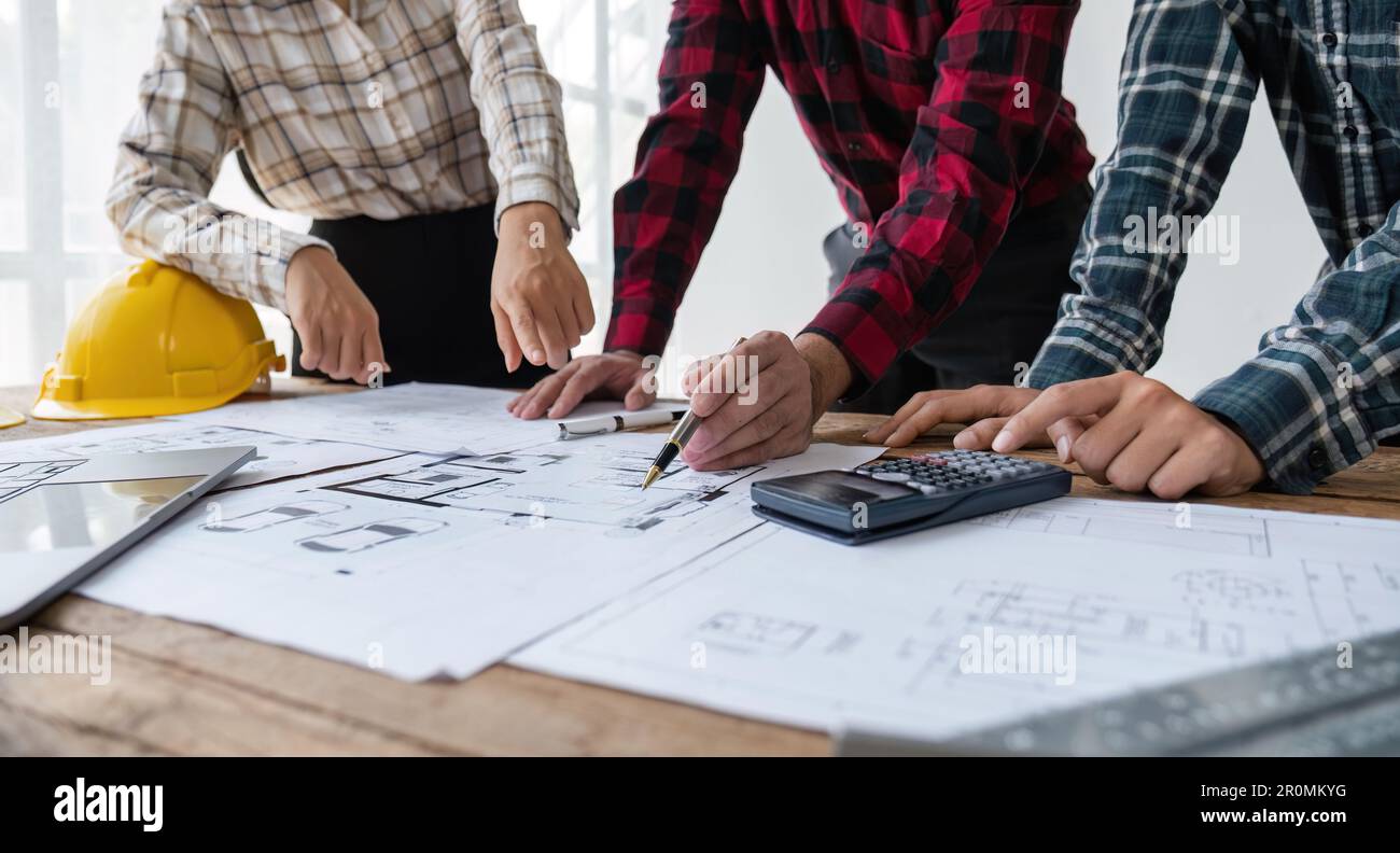 engineer people meeting working and pointing at a blueprint in office ...
