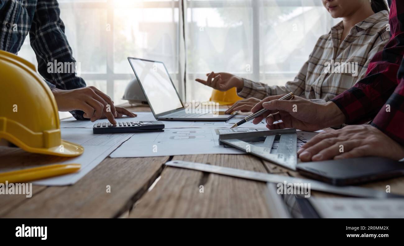 Team of structural engineers working in office looking at laptop ...