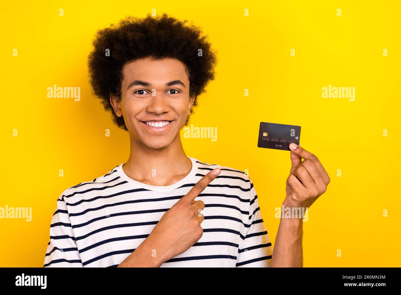 Portrait of young guy wear striped t-shirt directing finger new debit ...