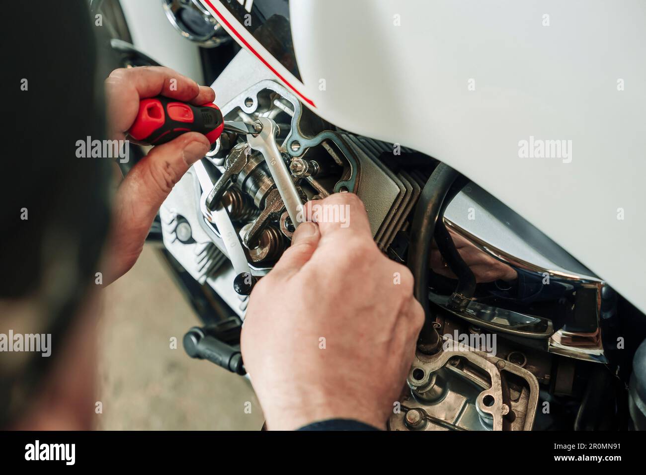 adjusting engine valves of motorcycle at the workshop Stock Photo - Alamy