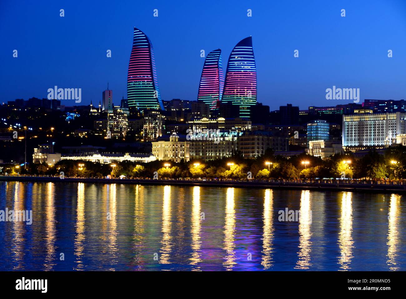 Evening view from the waterfront over Baku Bay to the Flame Towers with ...