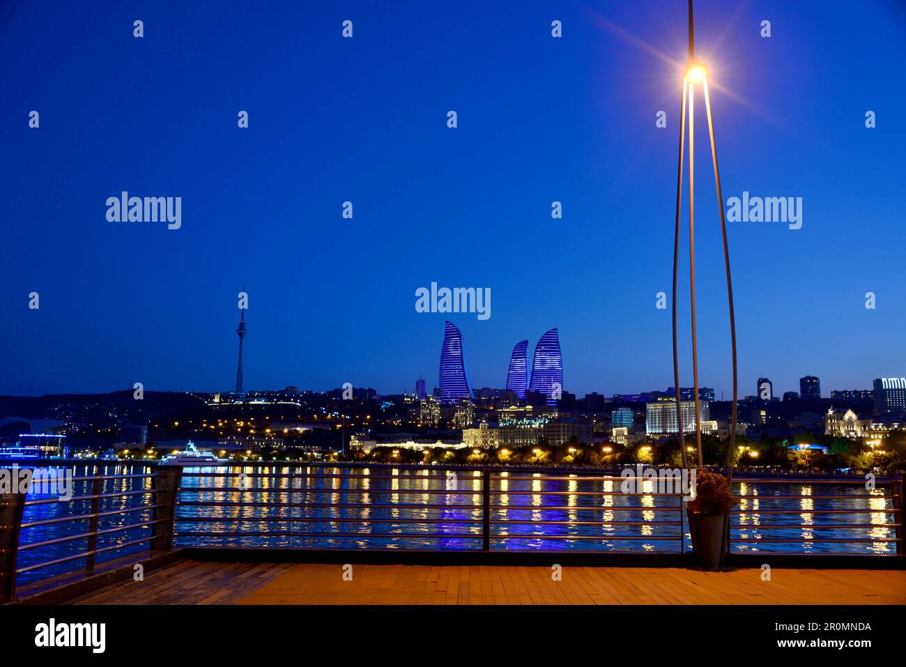 Evening view from the waterfront over Baku Bay to the Flame Towers with ...