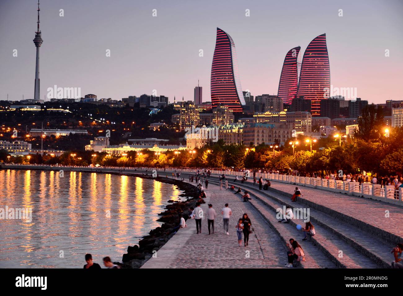 Evening view from the waterfront over Baku Bay to the Flame Towers with ...